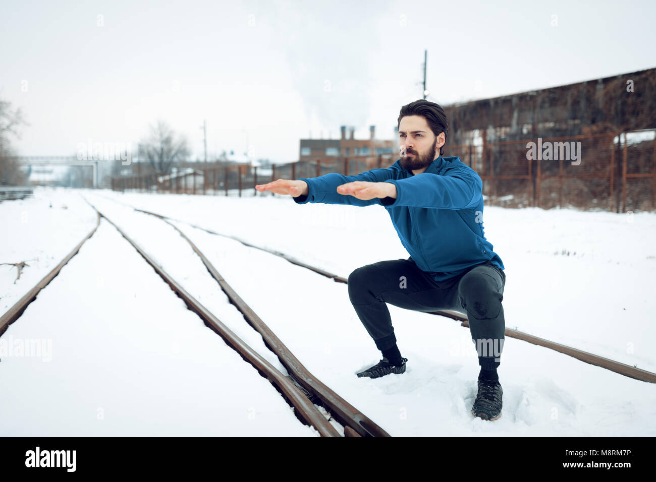 Young man crouching hi-res stock photography and images - Alamy