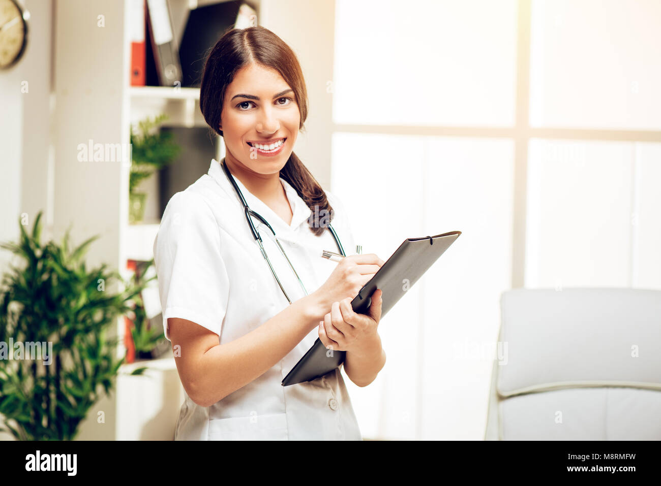 Portrait of a beautiful young female doctor standing in her consulting ...