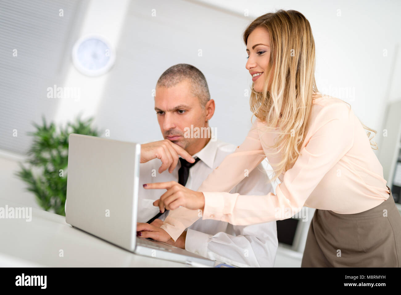 Professional male and female business partners having meeting to ...