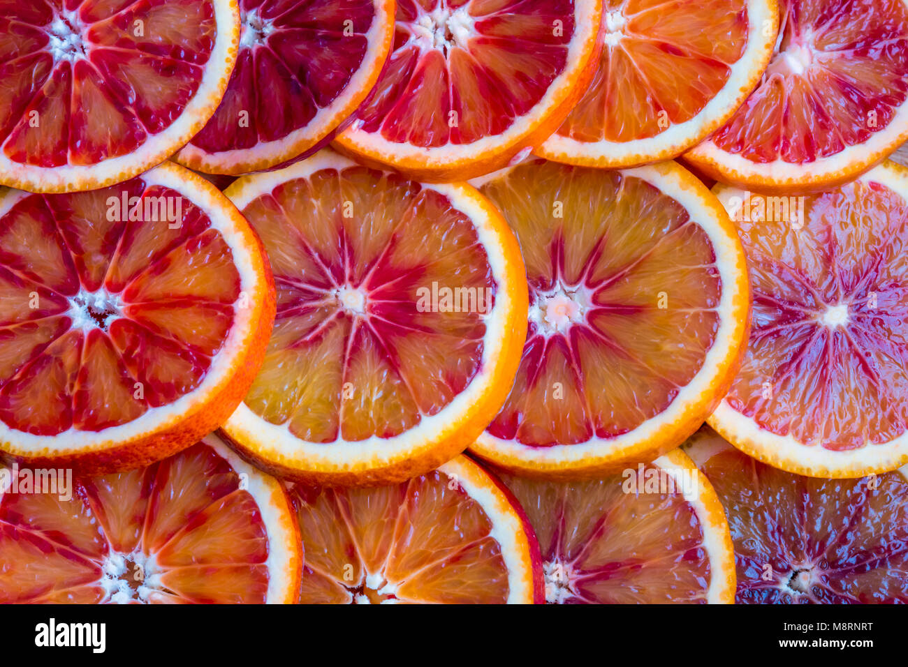 round slices of red orange, background and texture Stock Photo - Alamy
