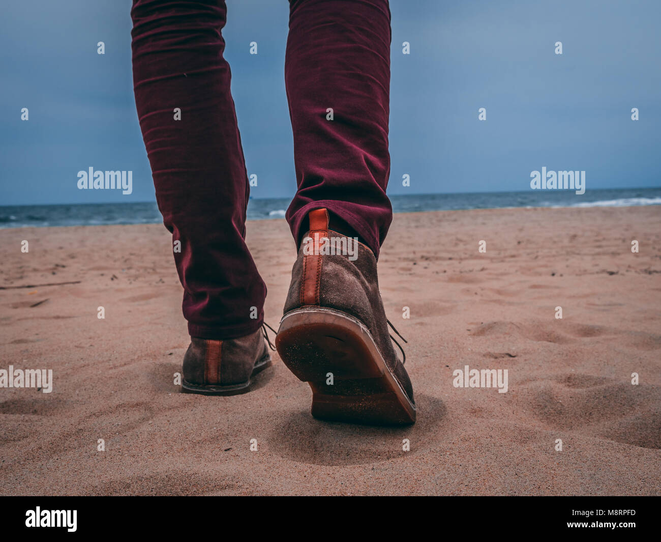 Man walking in the sand Stock Photo - Alamy