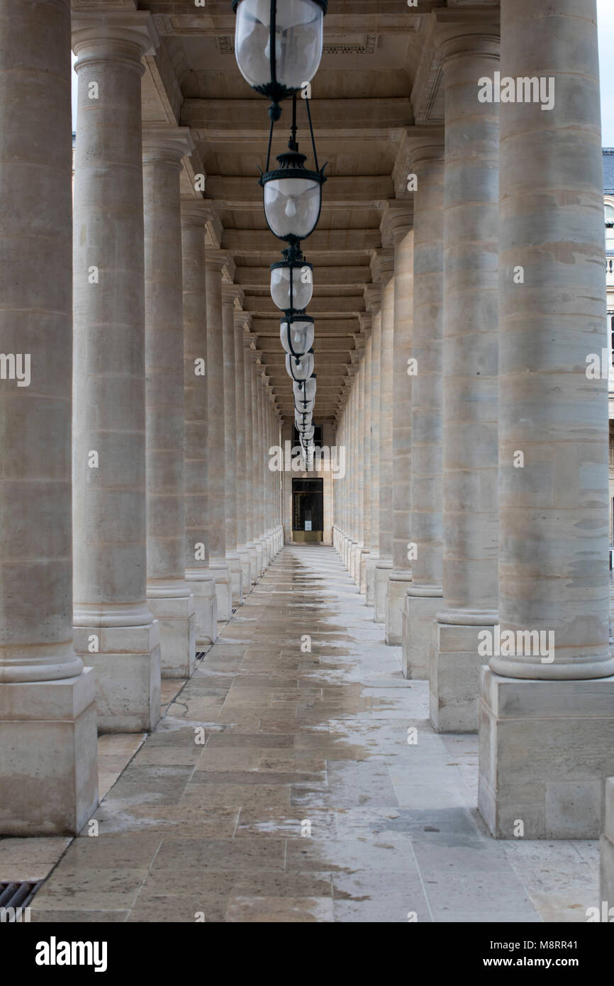 Lanterns hanging amidst architectural columns in historical building ...