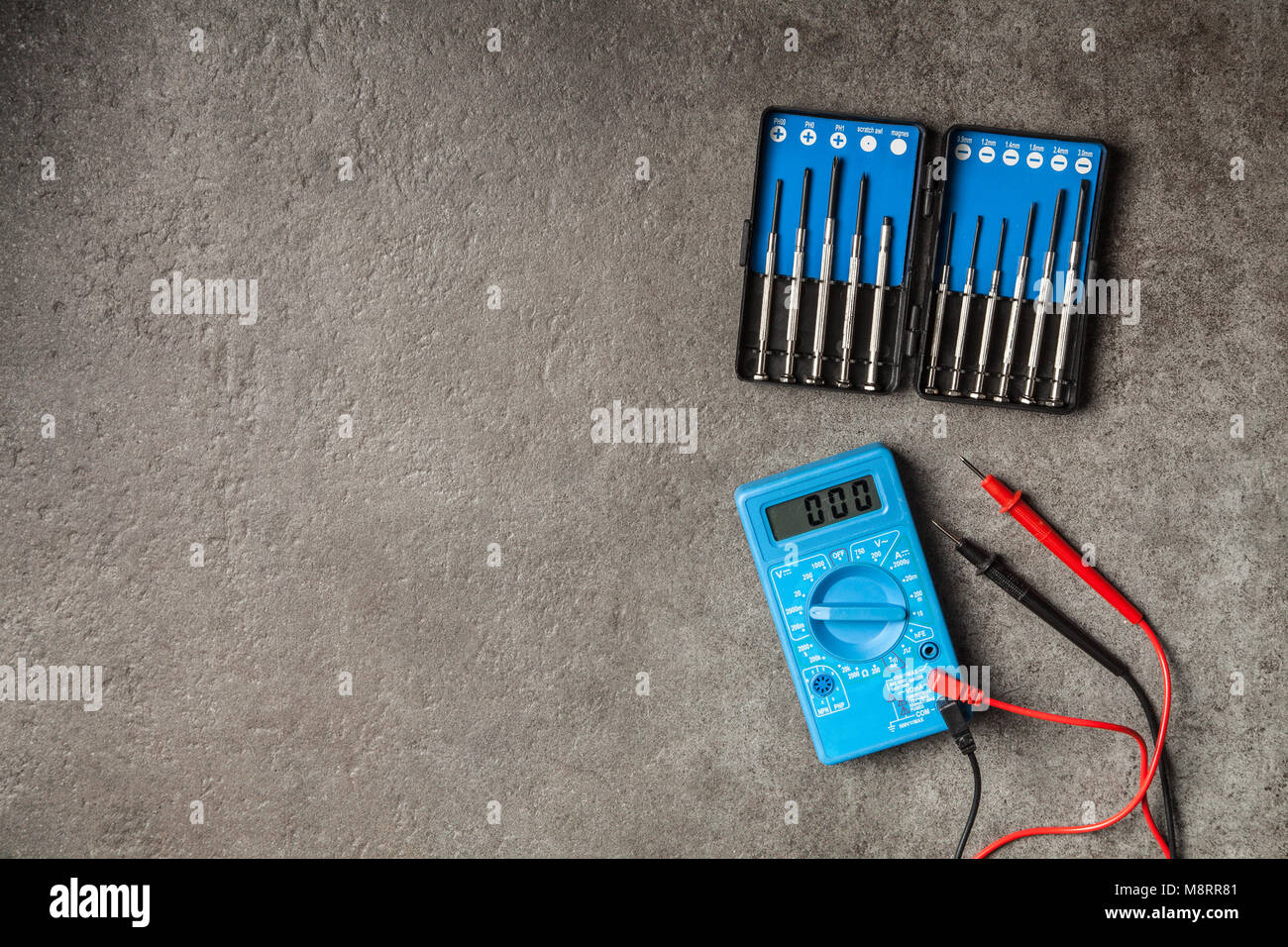 Digital multimeter on grey background Stock Photo - Alamy