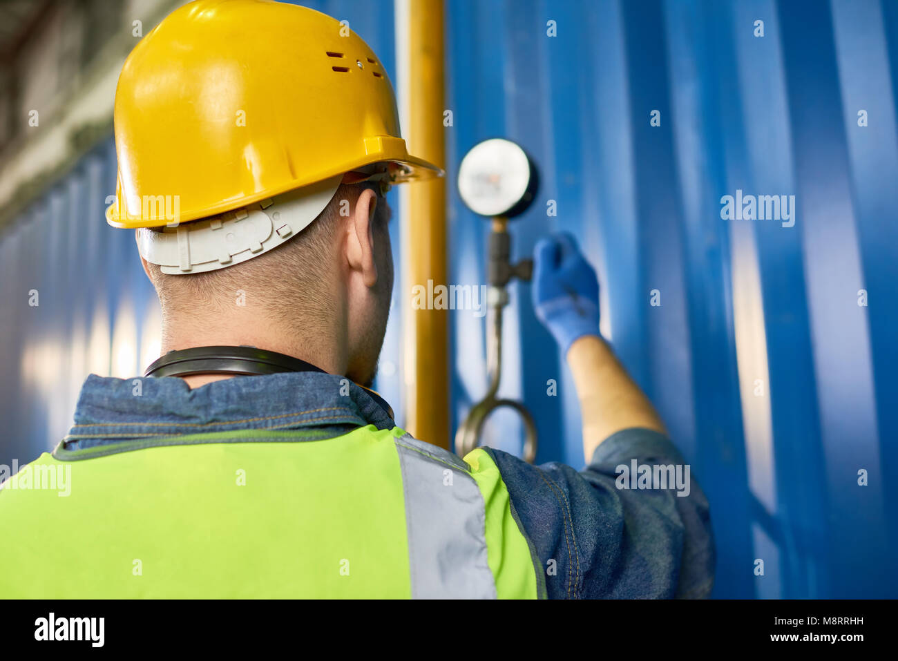 Worker Checking Equipment at Plant Stock Photo - Alamy