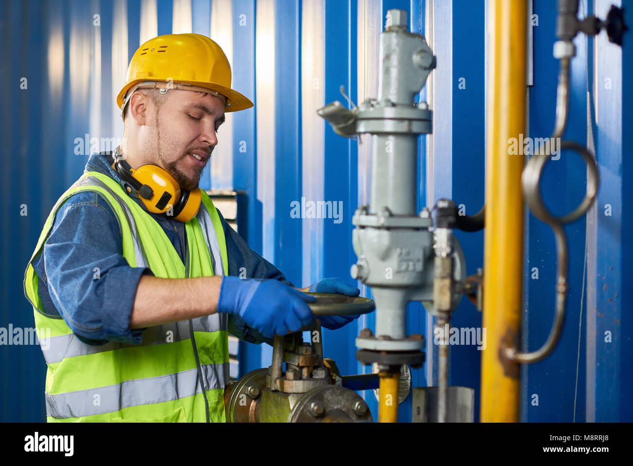 Young Plumber at Modern Plant Stock Photo - Alamy
