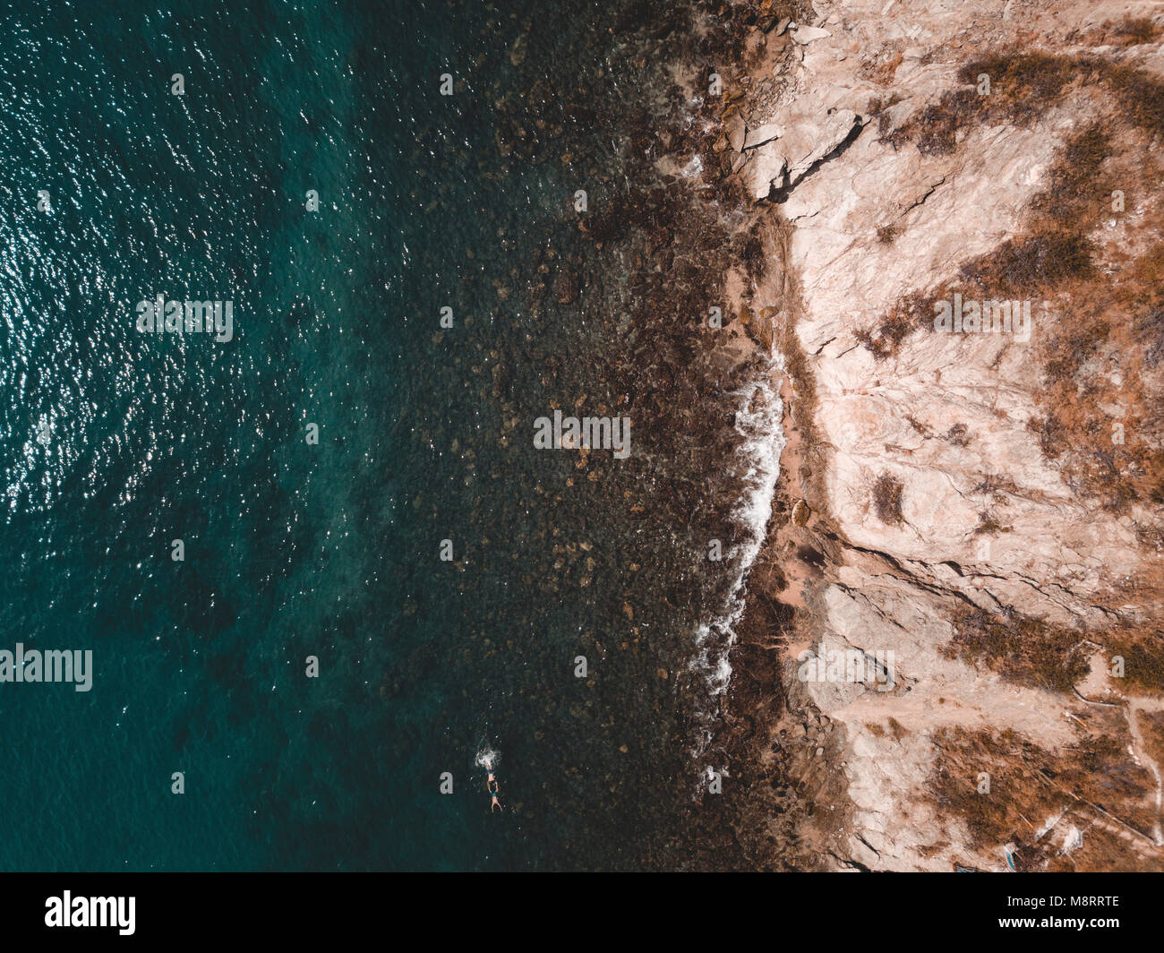 Aerial view of cliff by sea during sunny day Stock Photo - Alamy