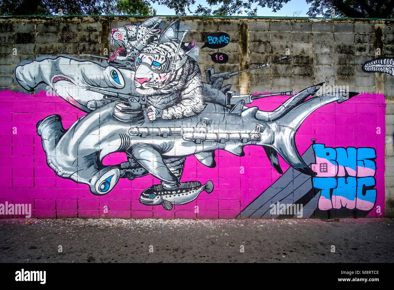 Colorful graffiti of phantasy sharks and lions with weapons at a wall ...