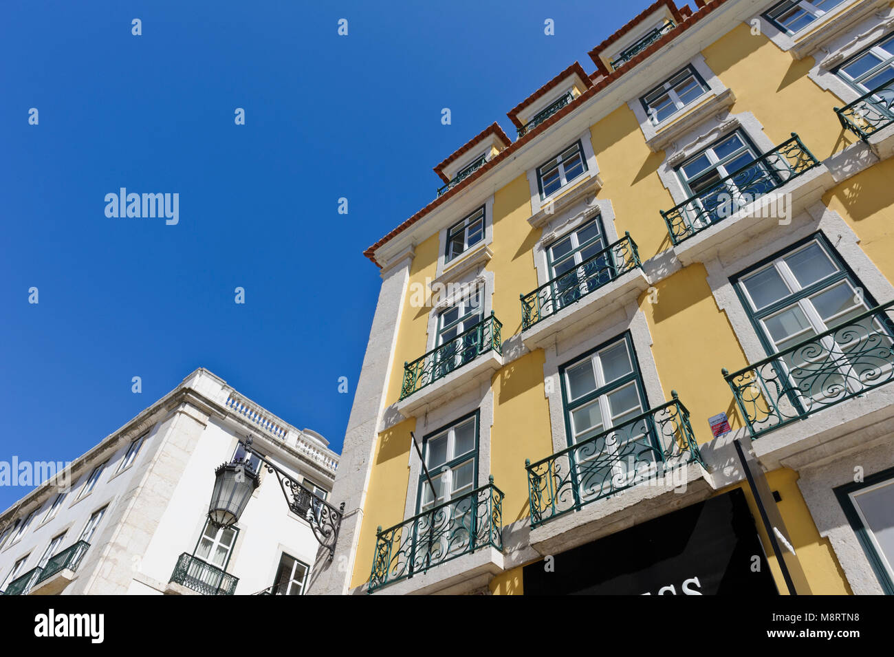 The exterior of a traditional building with balconies in Lisbon ...