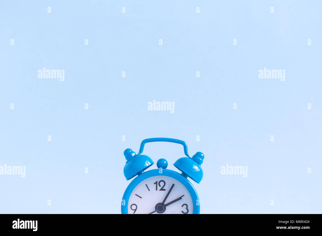 Alarm clock on pastel blue background. Space for copy. Minimal concept ...