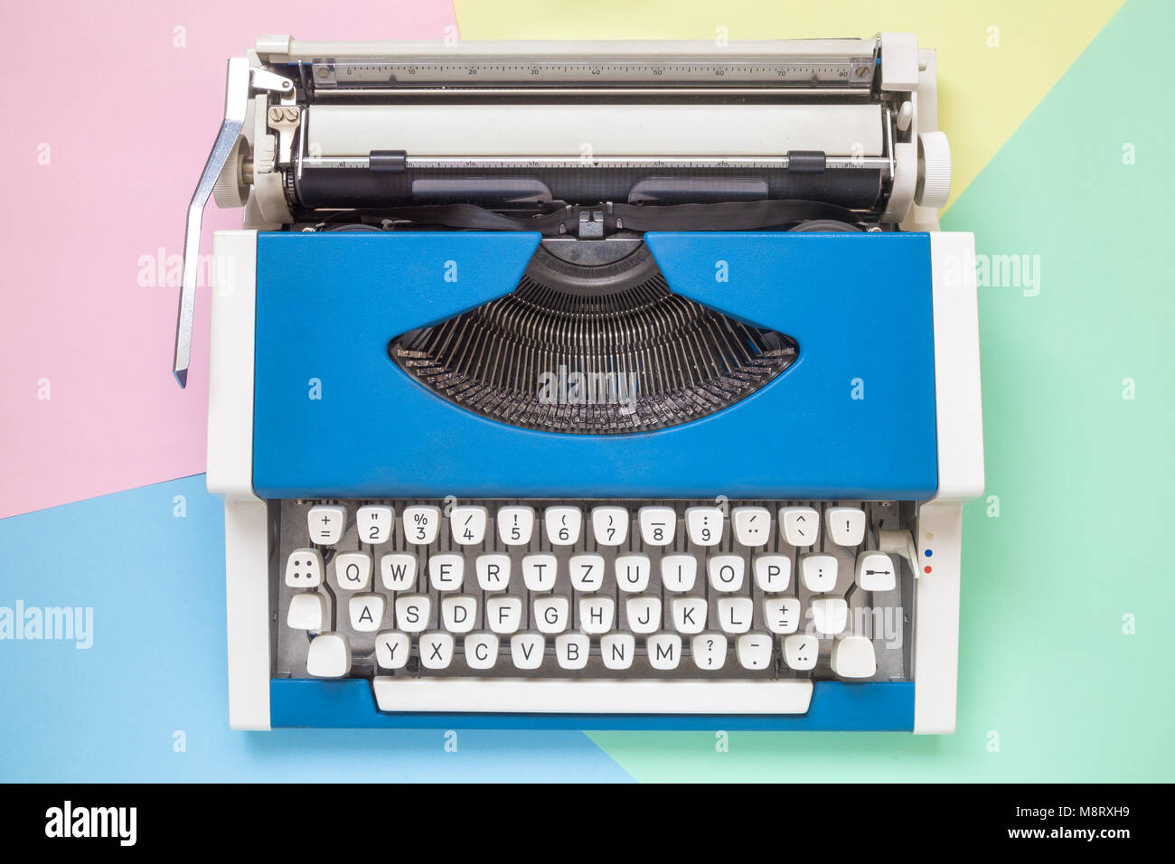 Typewriter with blank keyboard on colorful patel background Stock Photo ...