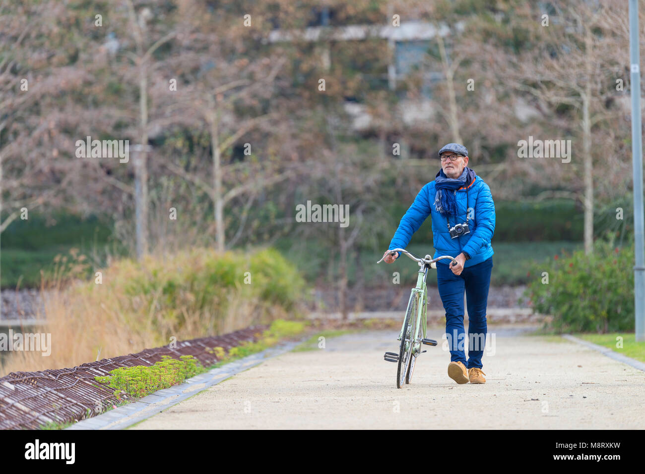 Man walking bicycle hi-res stock photography and images - Alamy