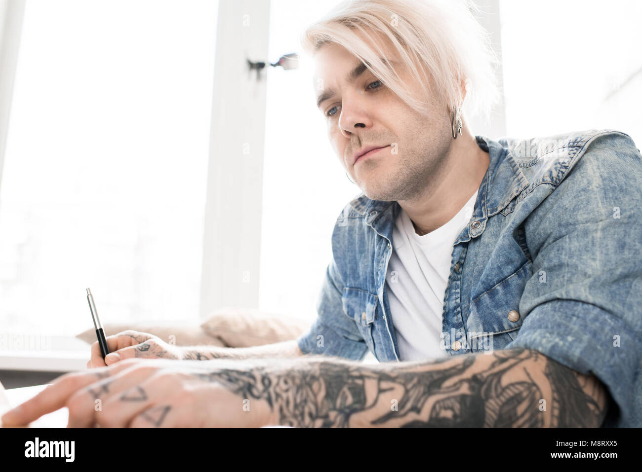 Adult student reading book Stock Photo - Alamy