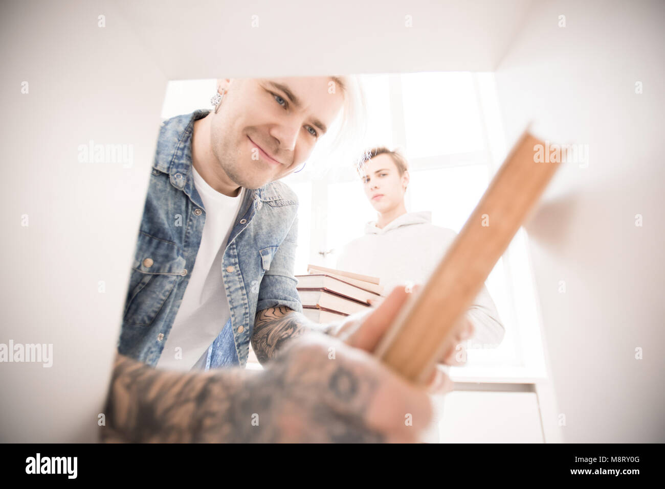 Adult student taking book Stock Photo - Alamy