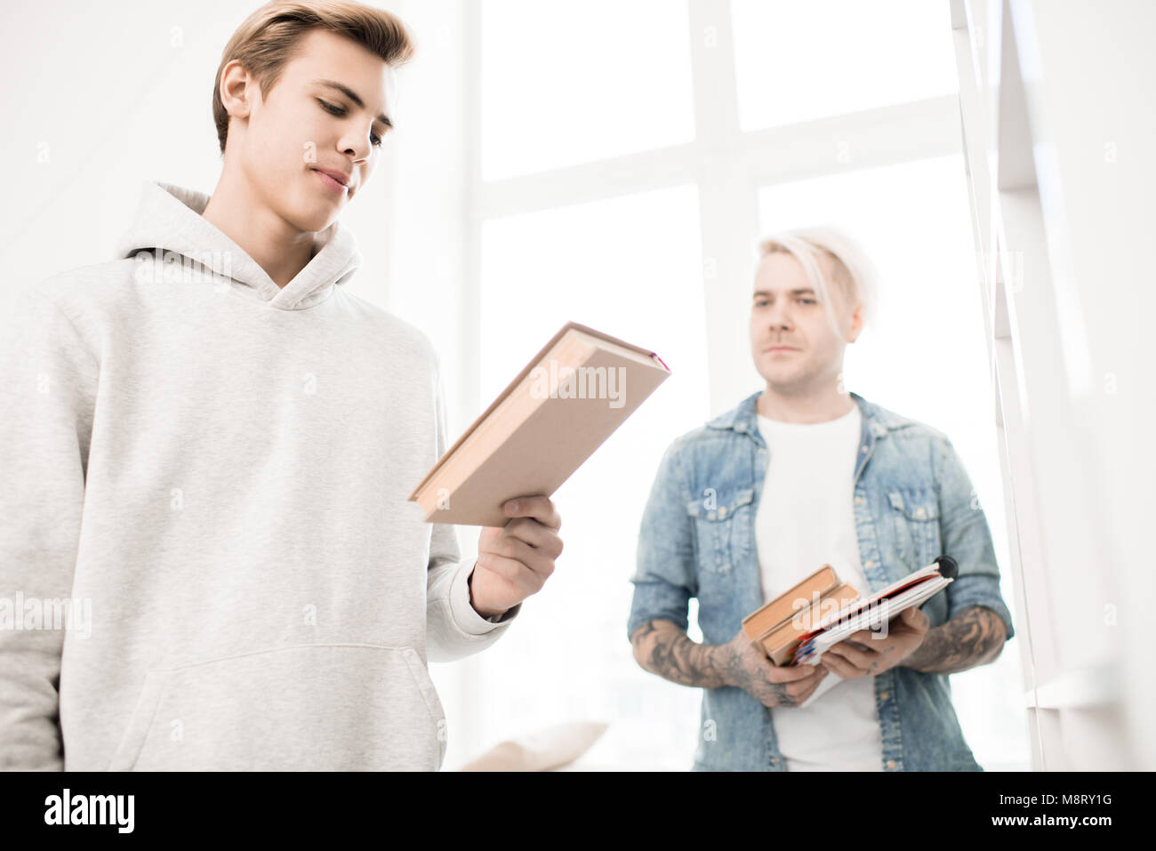 Students taking books in library Stock Photo - Alamy