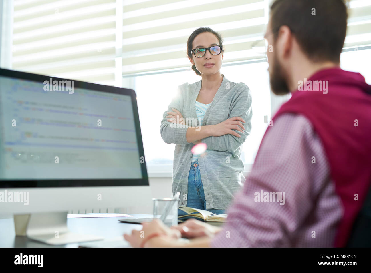 Colleagues communicating at work Stock Photo - Alamy