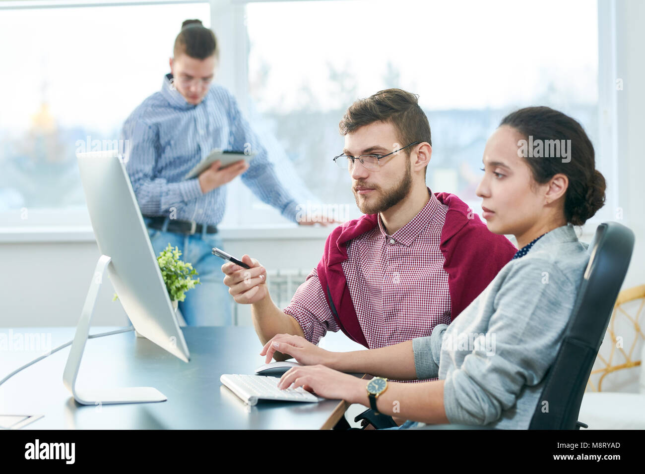 Young manager learning at work Stock Photo - Alamy