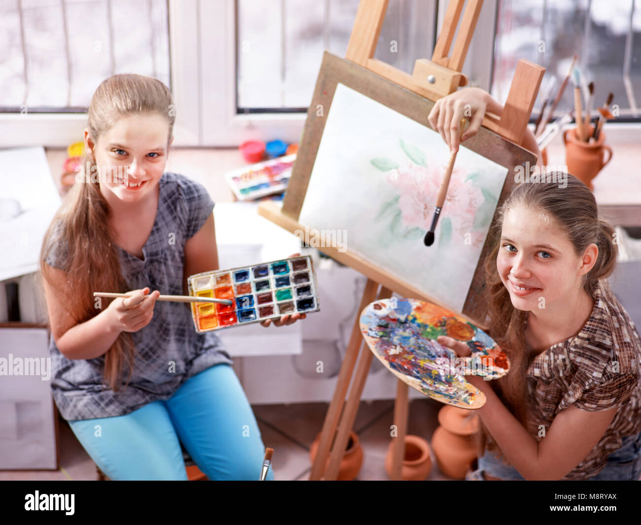 Artist painting on easel in studio. Authentic children paints Stock ...