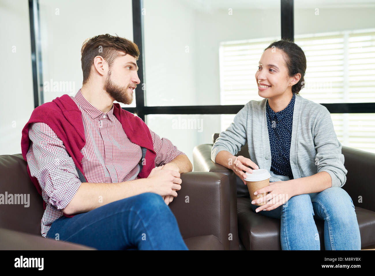 Coworkers talking over coffee Stock Photo - Alamy