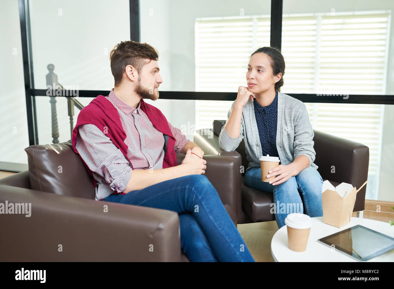 Colleagues resting in break room Stock Photo - Alamy