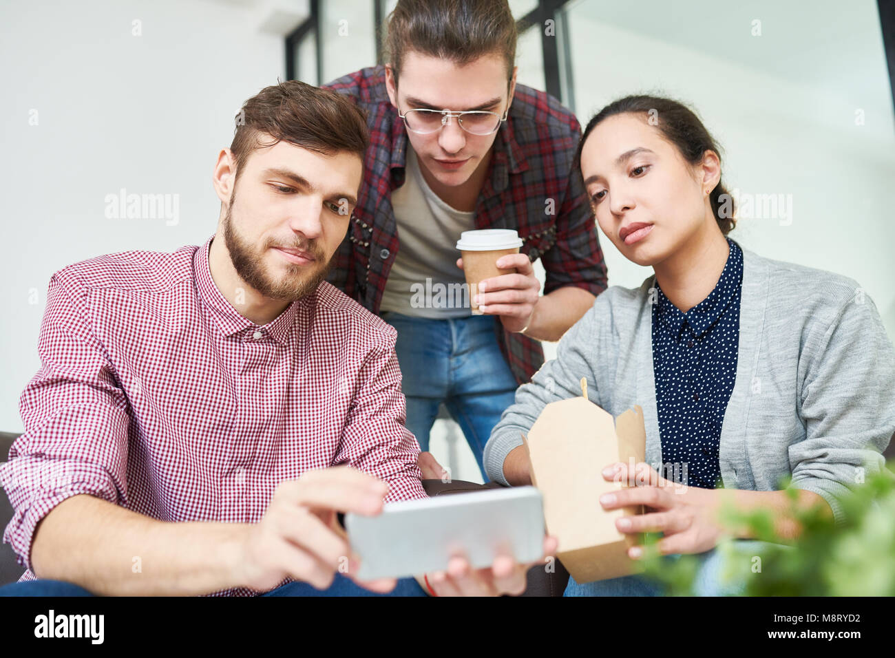Young colleagues break watching hi-res stock photography and images - Alamy