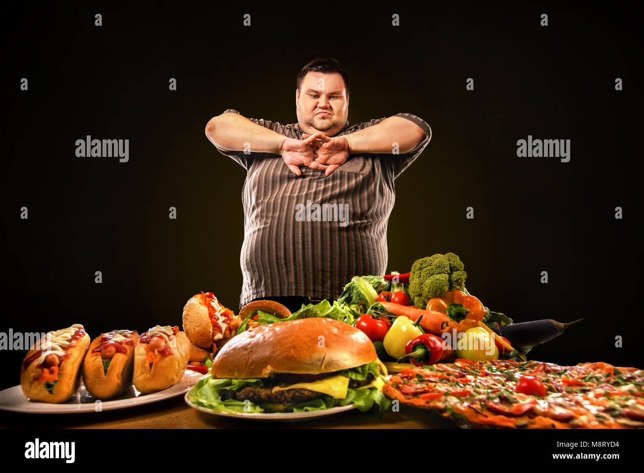 Diet fat man makes choice between healthy and unhealthy food Stock ...
