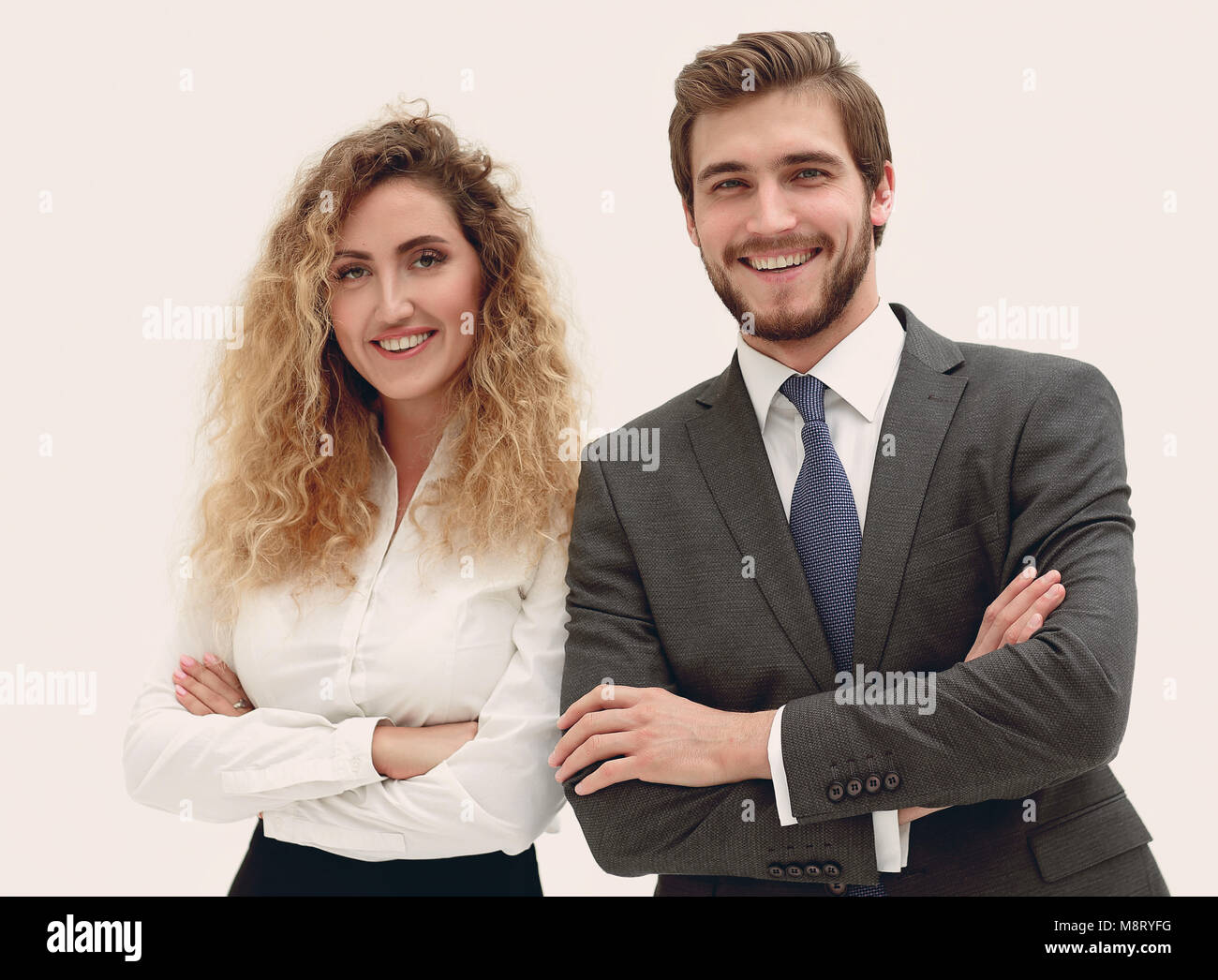 two young business people stand with arms folded Stock Photo - Alamy