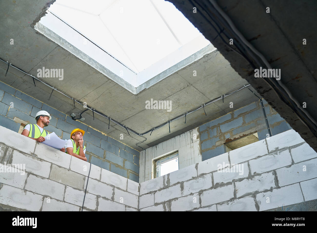 Two Builders on Construction Site Stock Photo - Alamy