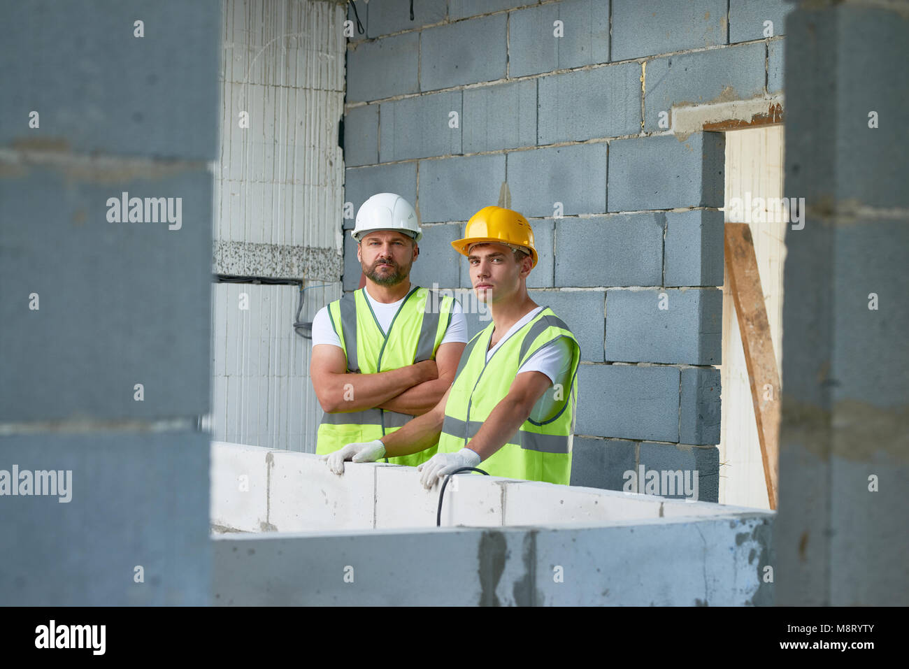 Construction Workers Posing on Site Stock Photo - Alamy