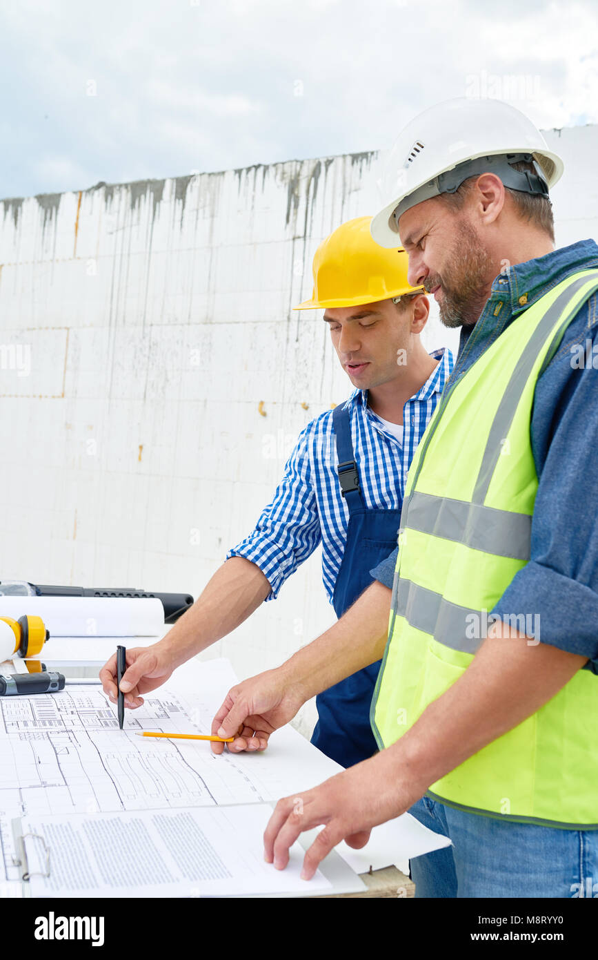 Two Builders Looking at Floor Plans Stock Photo - Alamy