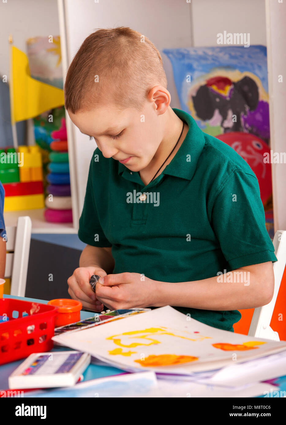 Plasticine modeling clay in children class. Teacher teaches in school ...