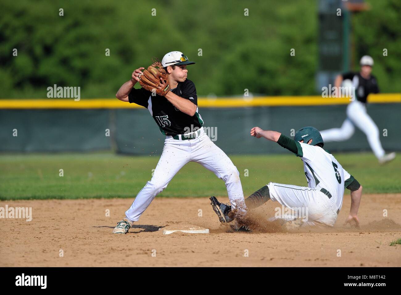 Second baseman relaying on to first base as the middle man in a double ...