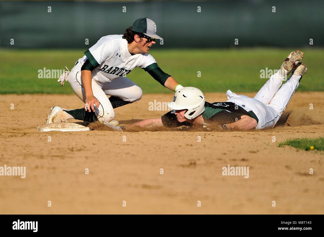 Second baseman applying a tag to retire a base runner at second base ...