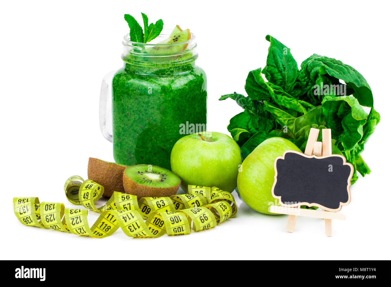 healthy green smoothie and ingredients on white - spinach, apple and ...