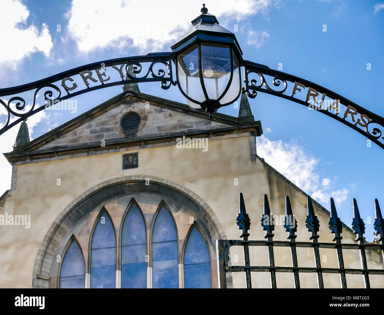 Close up Greyfriar's churchyard ornate gate with lantern and wrought ...