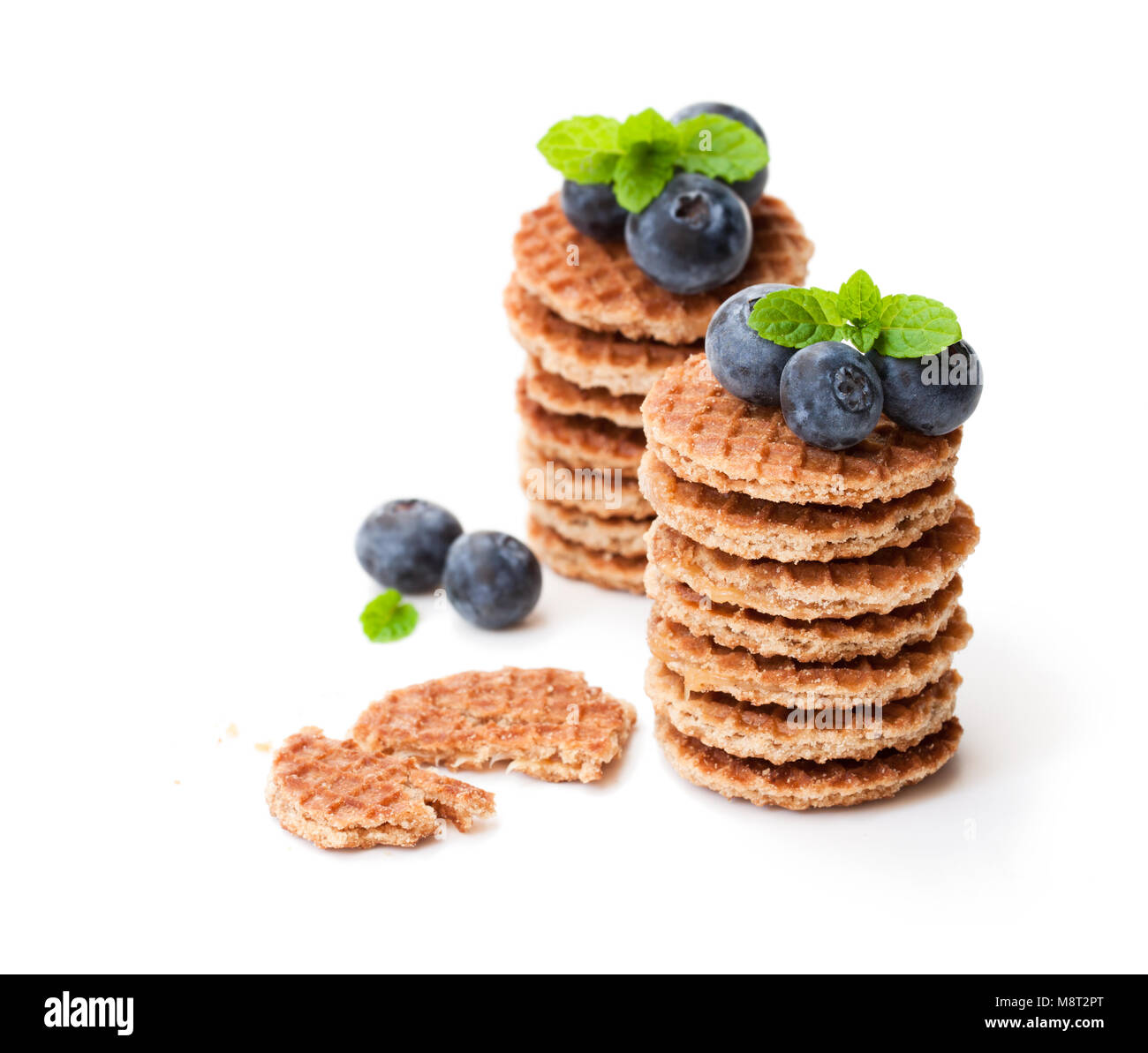 Stack of mini dutch caramel waffles with blueberry isolated on white ...