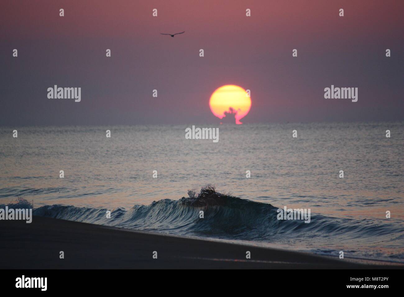 Molten Lava Sun Rising From The Sea Stock Photo - Alamy