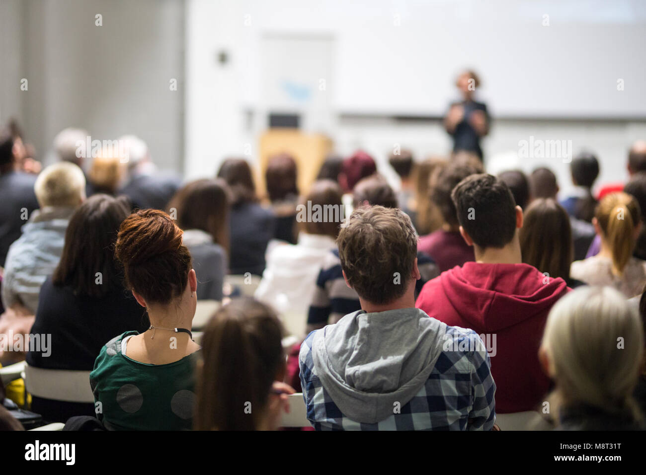 Female speaker giving presentation in lecture hall at university ...