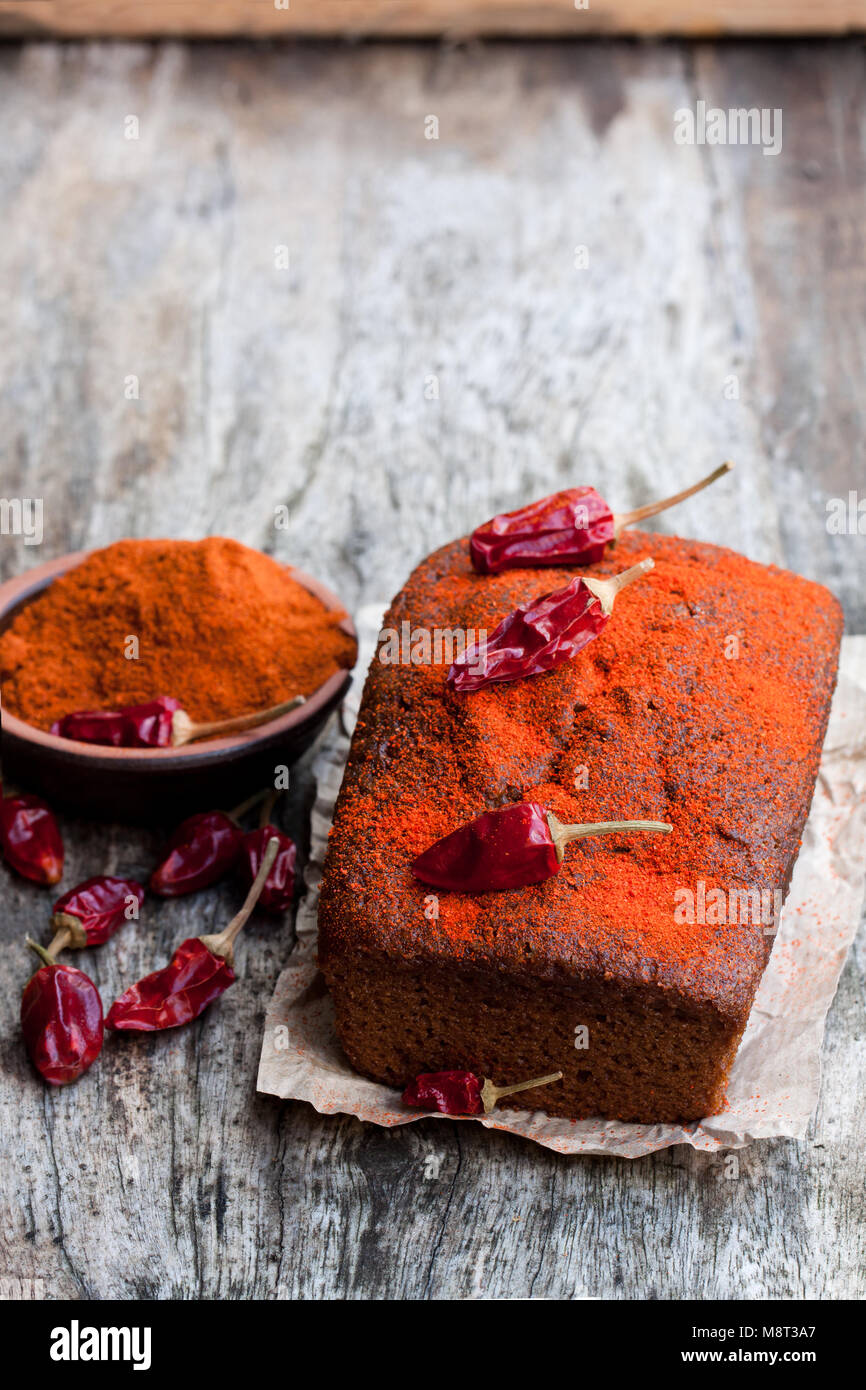 Delicious chocolate cake with chili pepper on wooden table Stock Photo ...