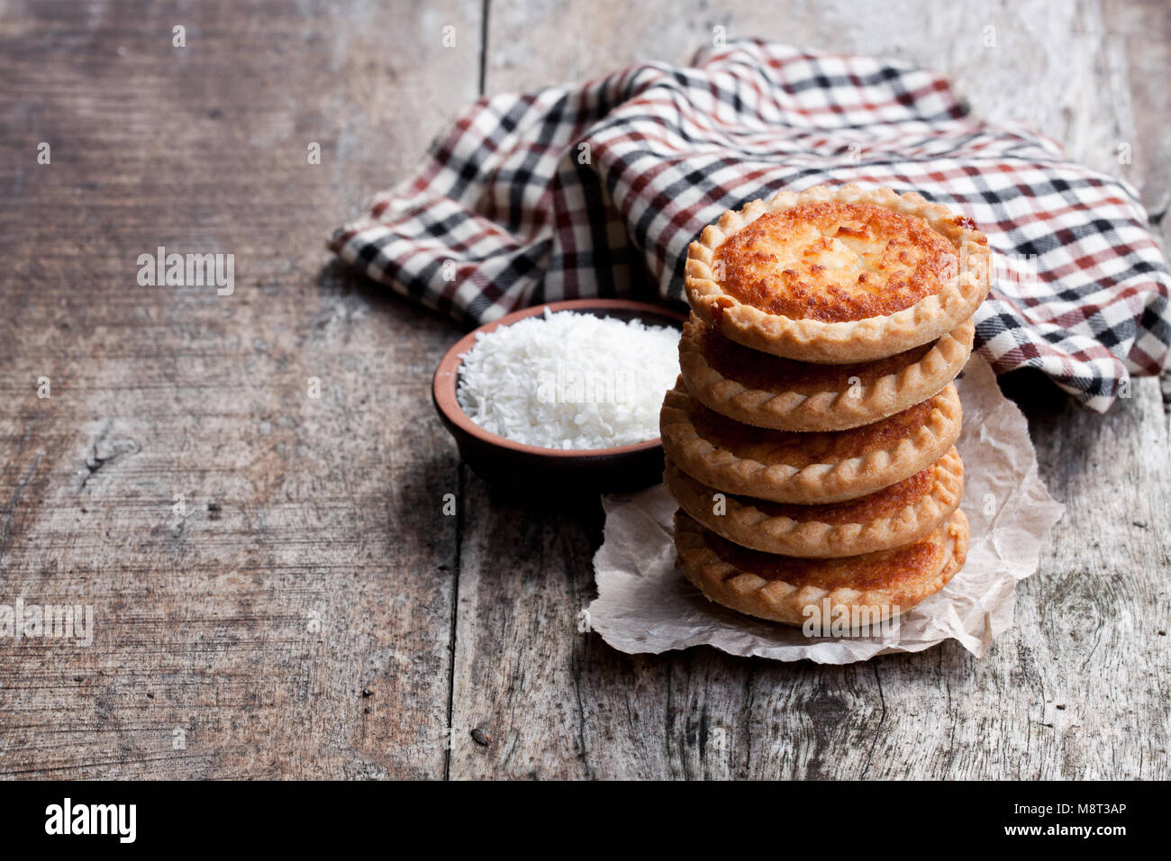 Stack of coconut tarts on wooden table Stock Photo - Alamy