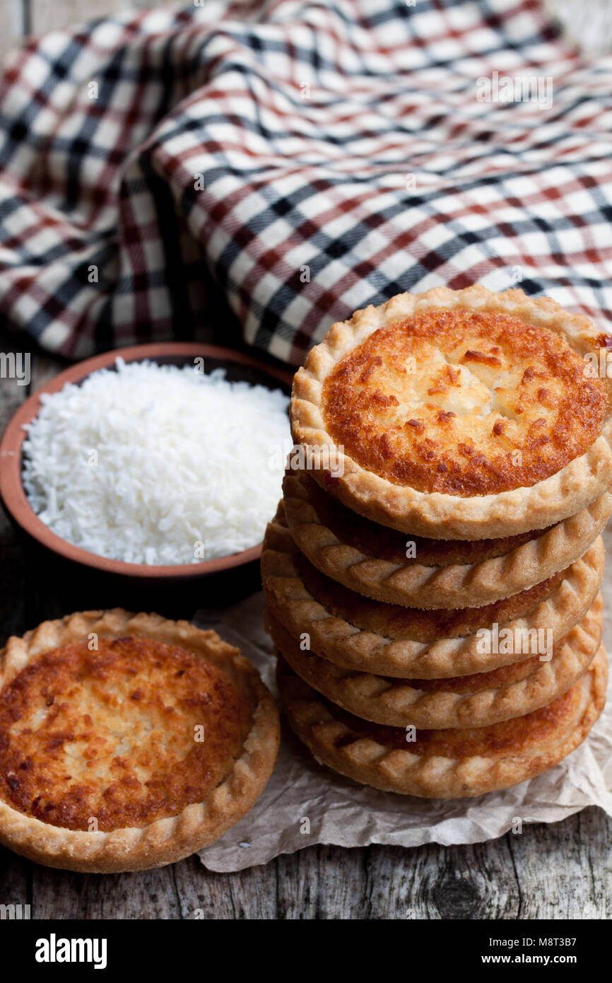 Stack of coconut tarts on wooden table Stock Photo - Alamy