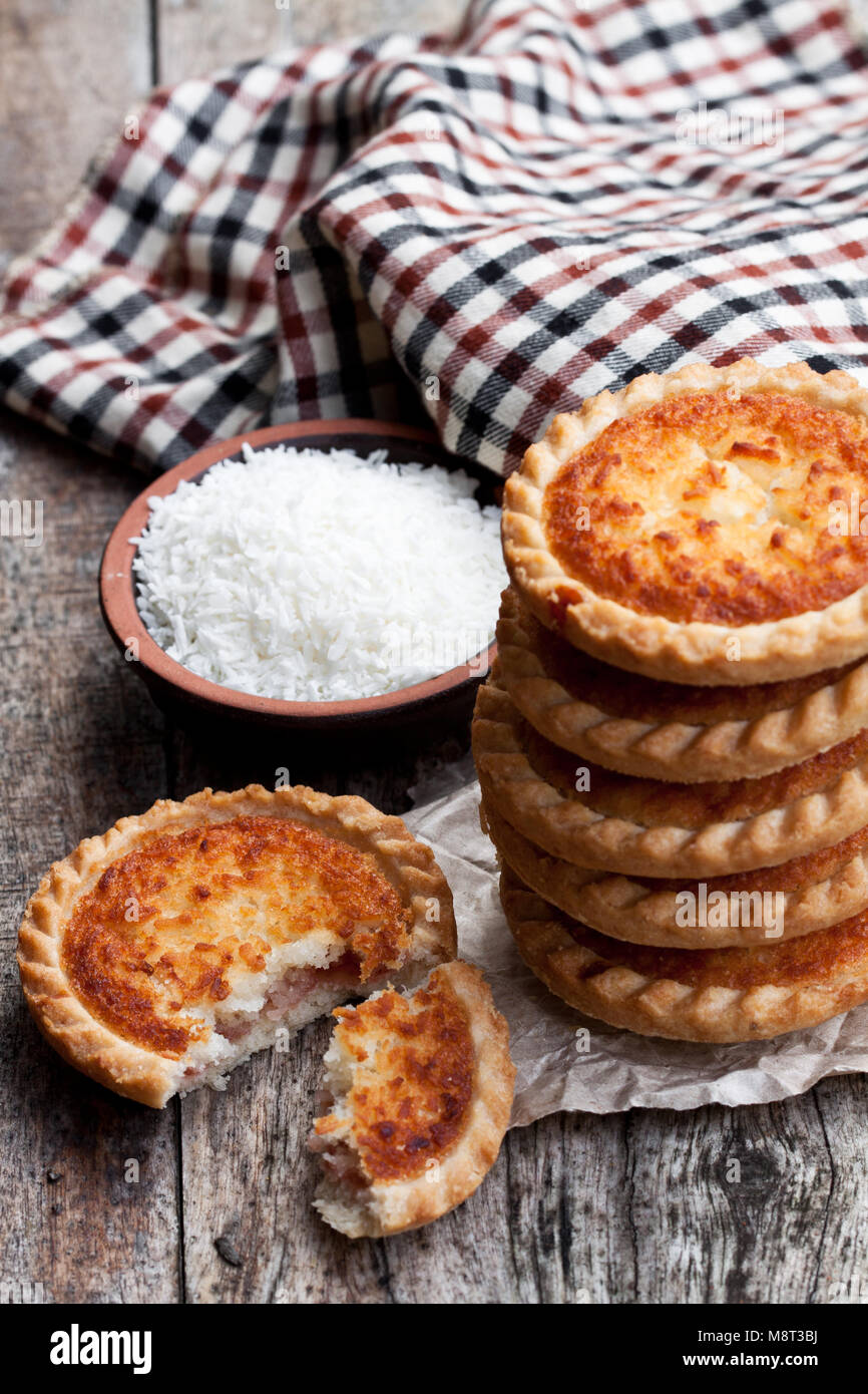 Stack of coconut tarts on wooden table Stock Photo - Alamy