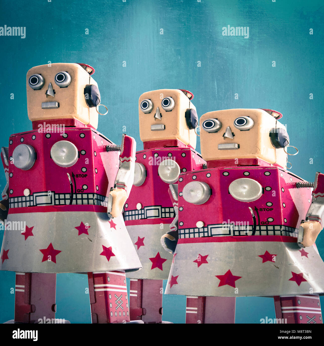 three girl robot toys looking forward, toned image Stock Photo - Alamy