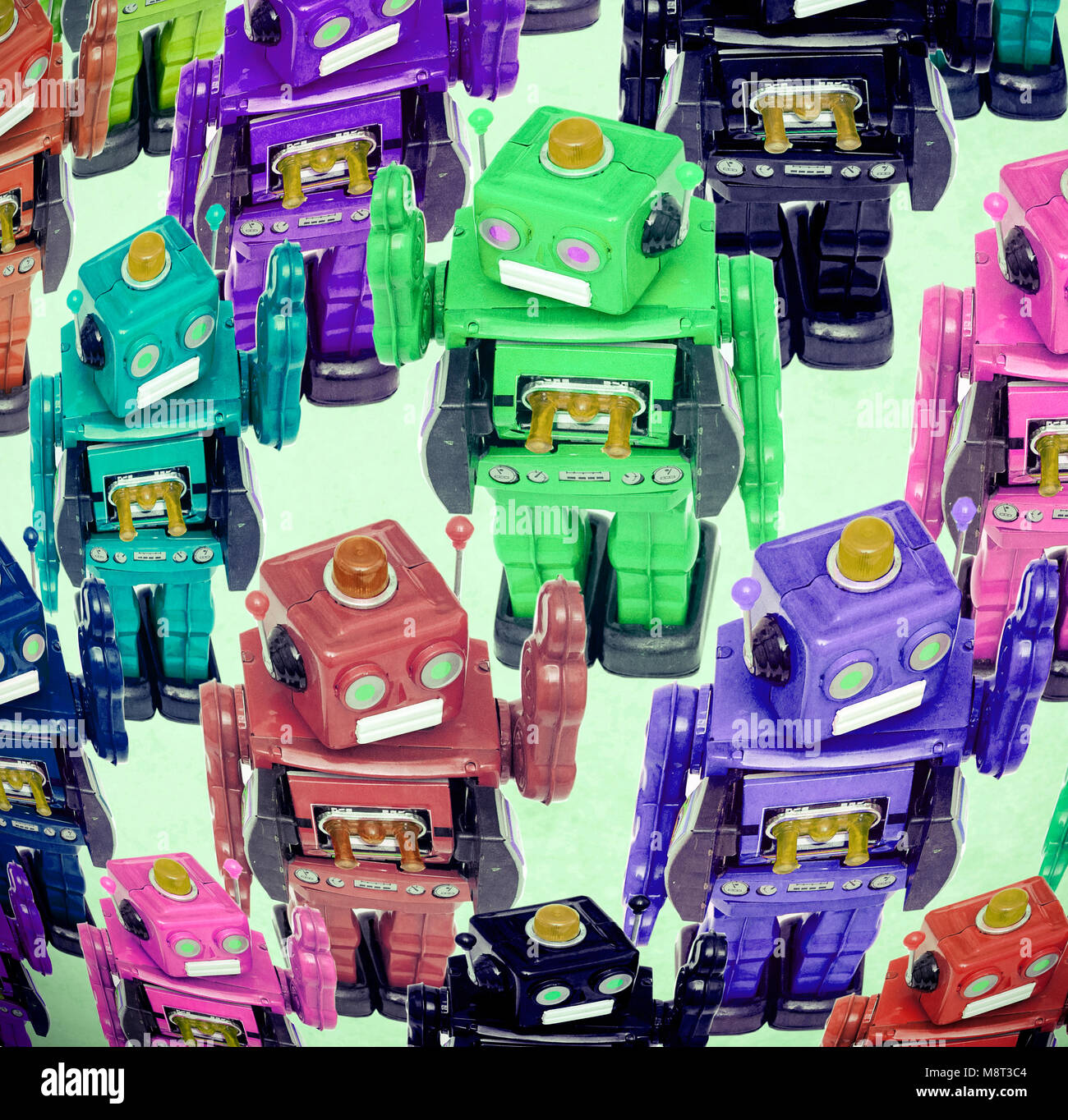 lots of robots in a crowd with one pink robot going the other direction ...