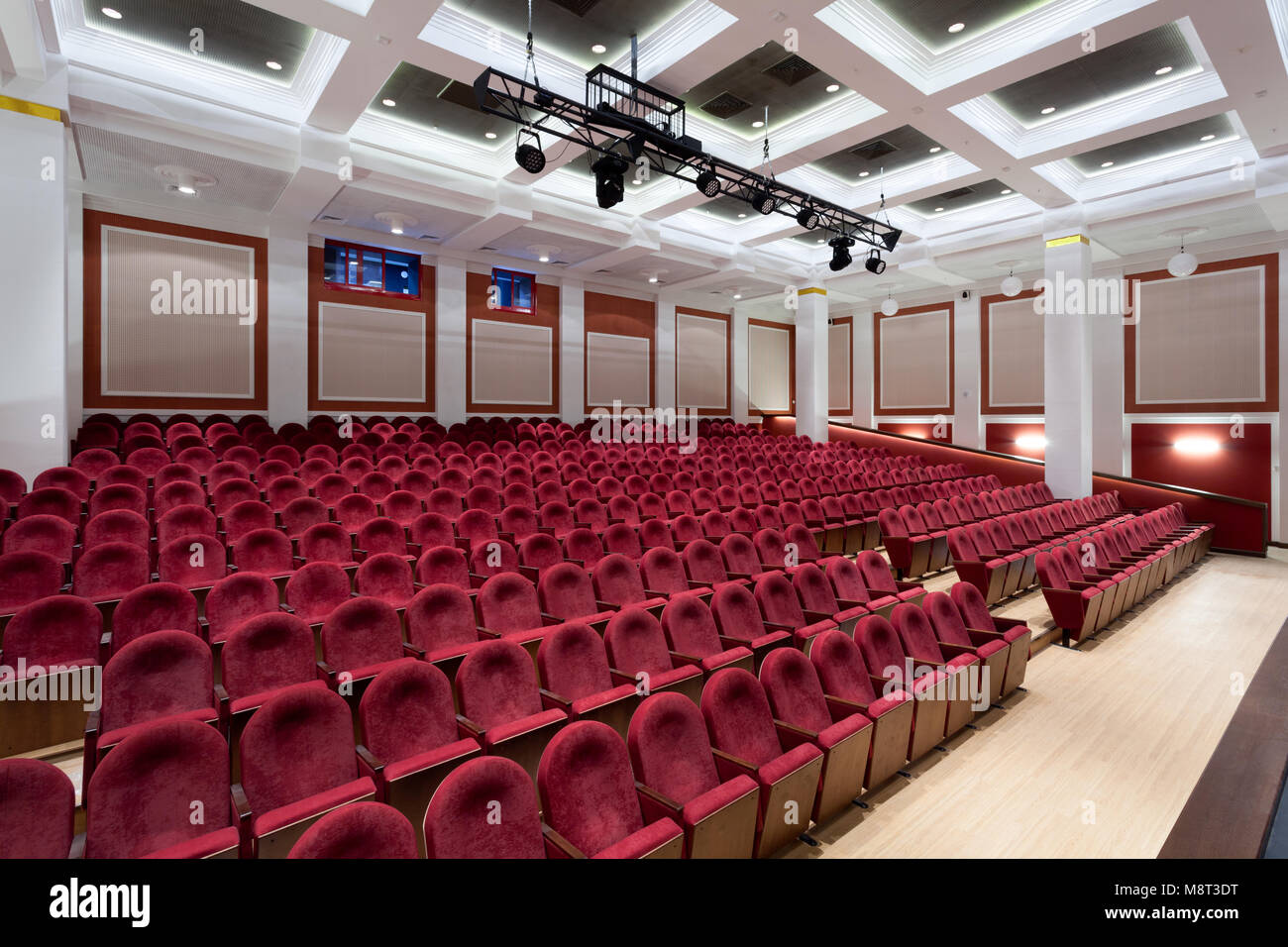 Concert hall of the cinema with red new chairs. The interior of the ...