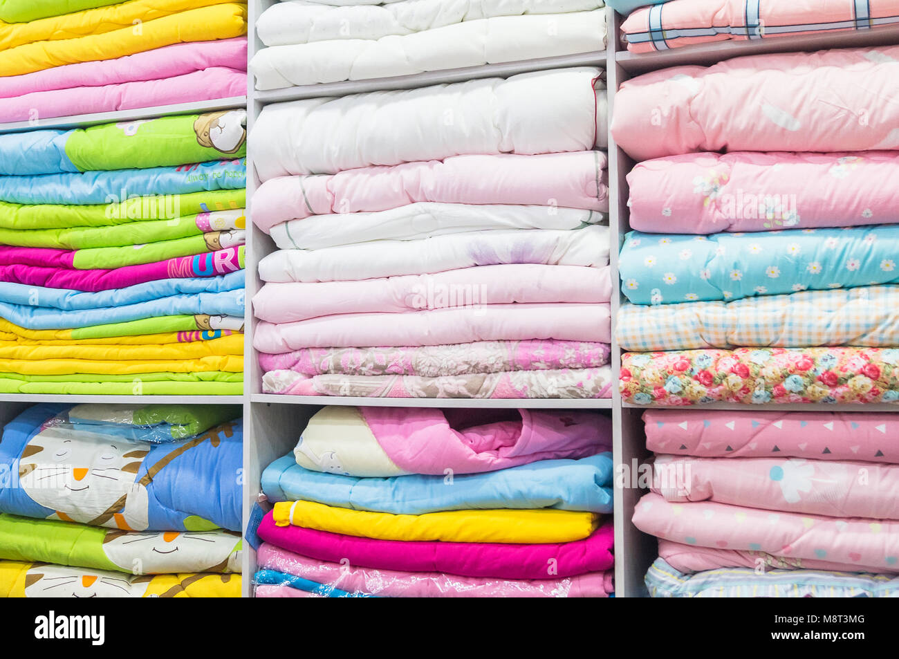 Bed linen is beautifully displayed on the shelves for sale in the ...