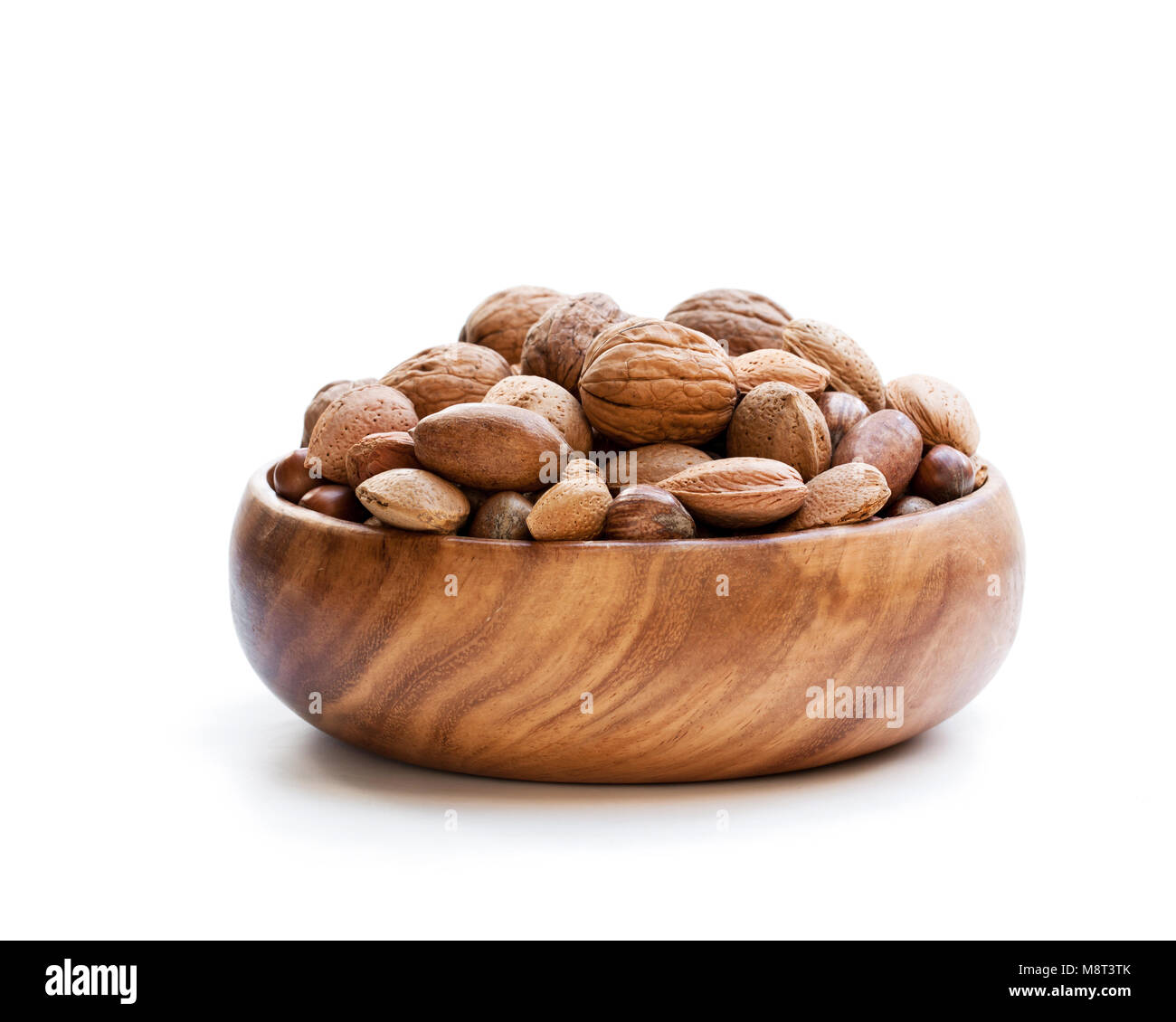 Various nuts in wooden bowl isolated on white Stock Photo - Alamy