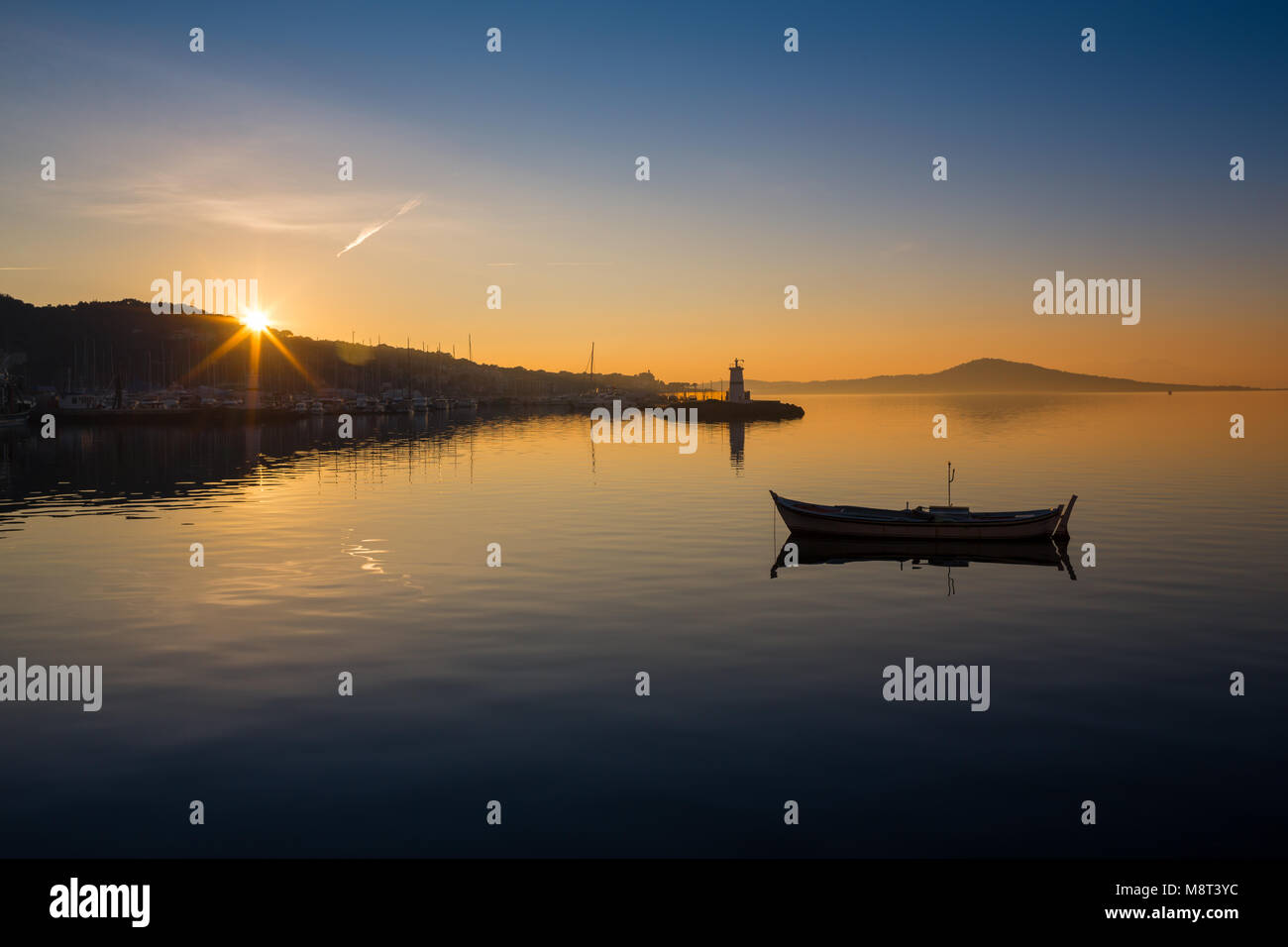A rowboat watches an amazing sunset Stock Photo - Alamy