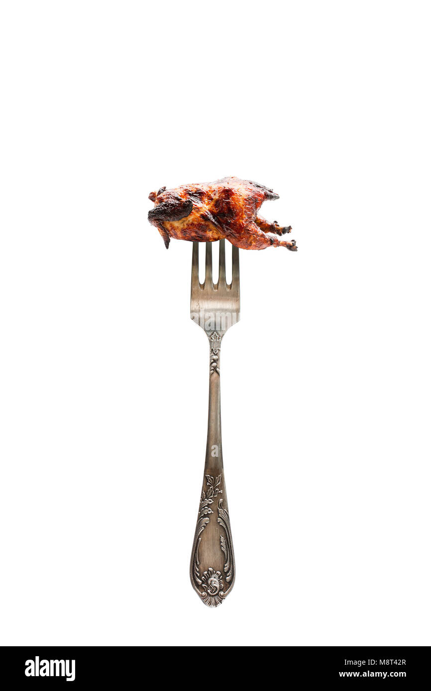Small grilled chicken on a big fork. Food balance choice portion ...