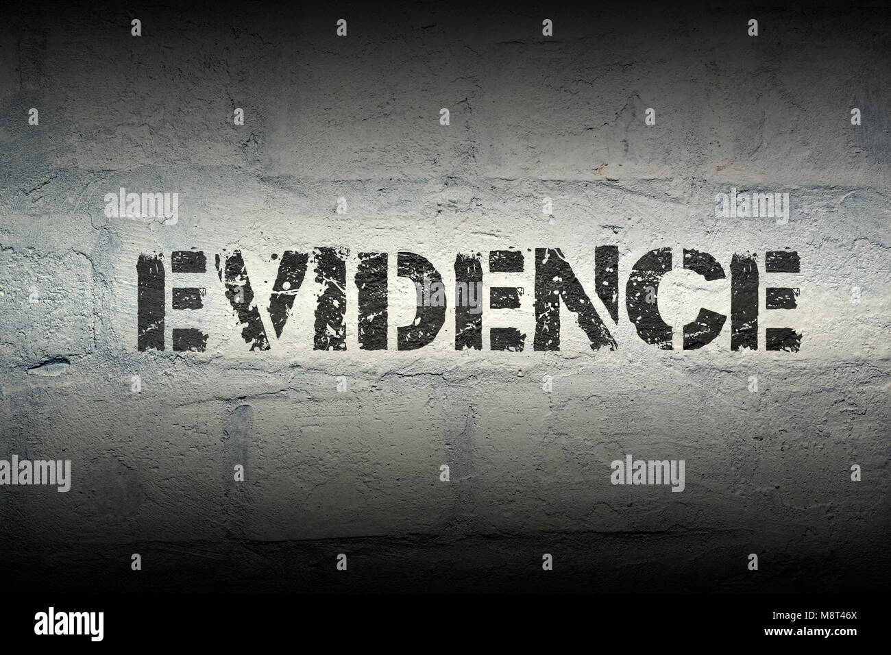 evidence stencil print on the grunge white brick wall Stock Photo - Alamy