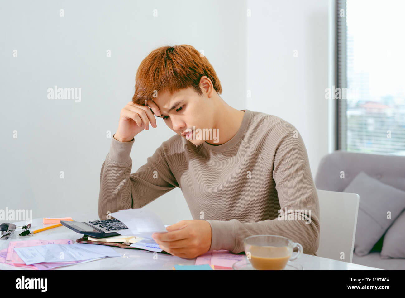 Asian man doing finances and calculate about cost at home office Stock ...